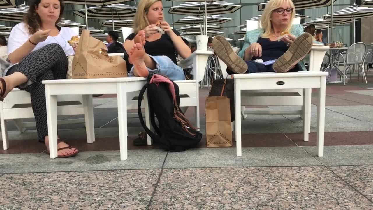 Three female strangers reveal their feet while eating at the restaurant ...
